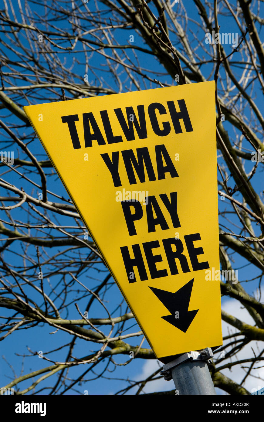 A pay sign in a car park in Wales. Written in both the English and ...