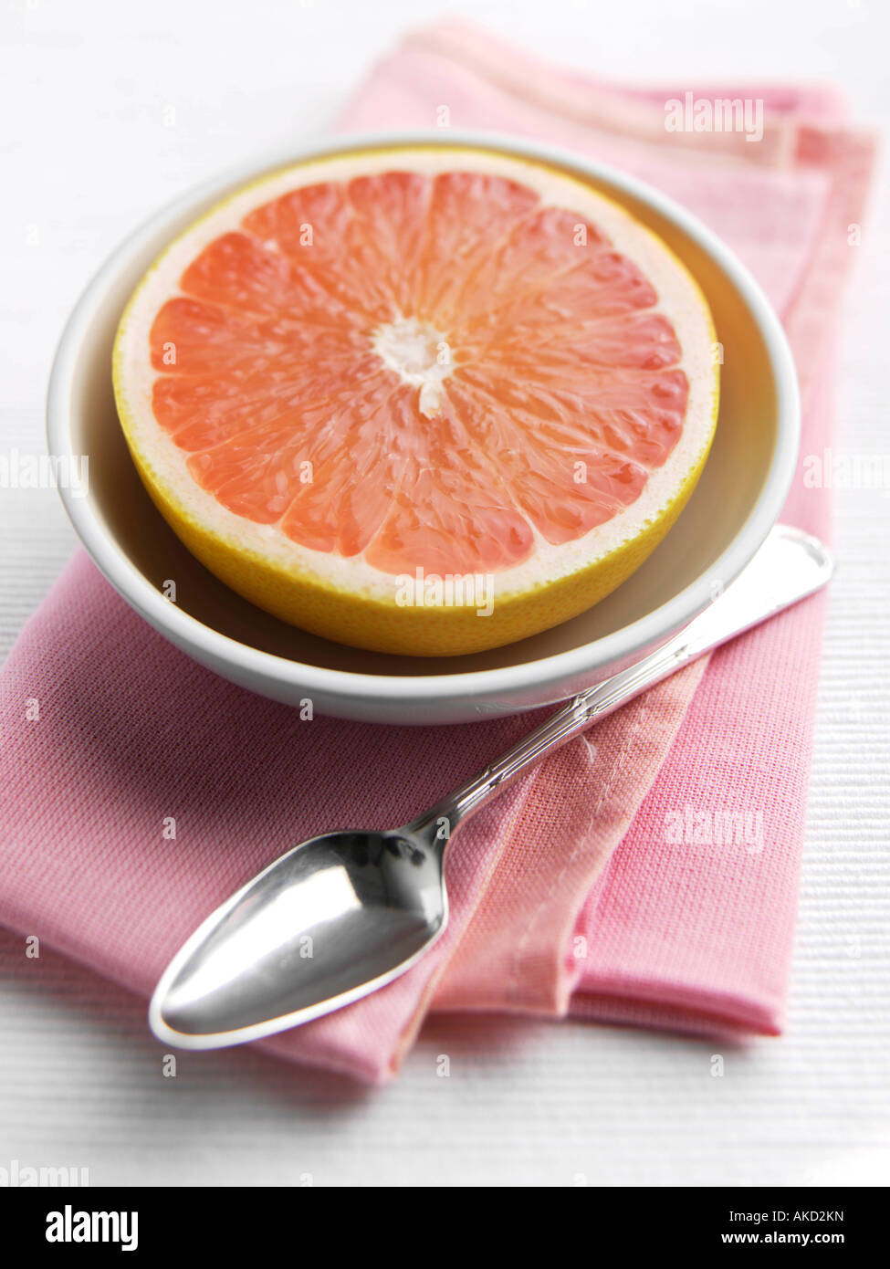 A fresh cut pink grapefruit for healthy vegetarian breakfast editorial ...