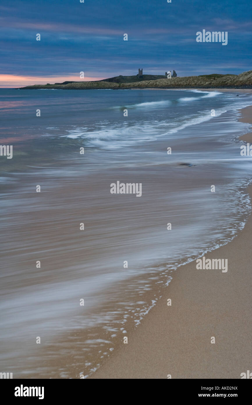 Receding waves and crisp light on Dunstanburgh Castle, Northumberland ...