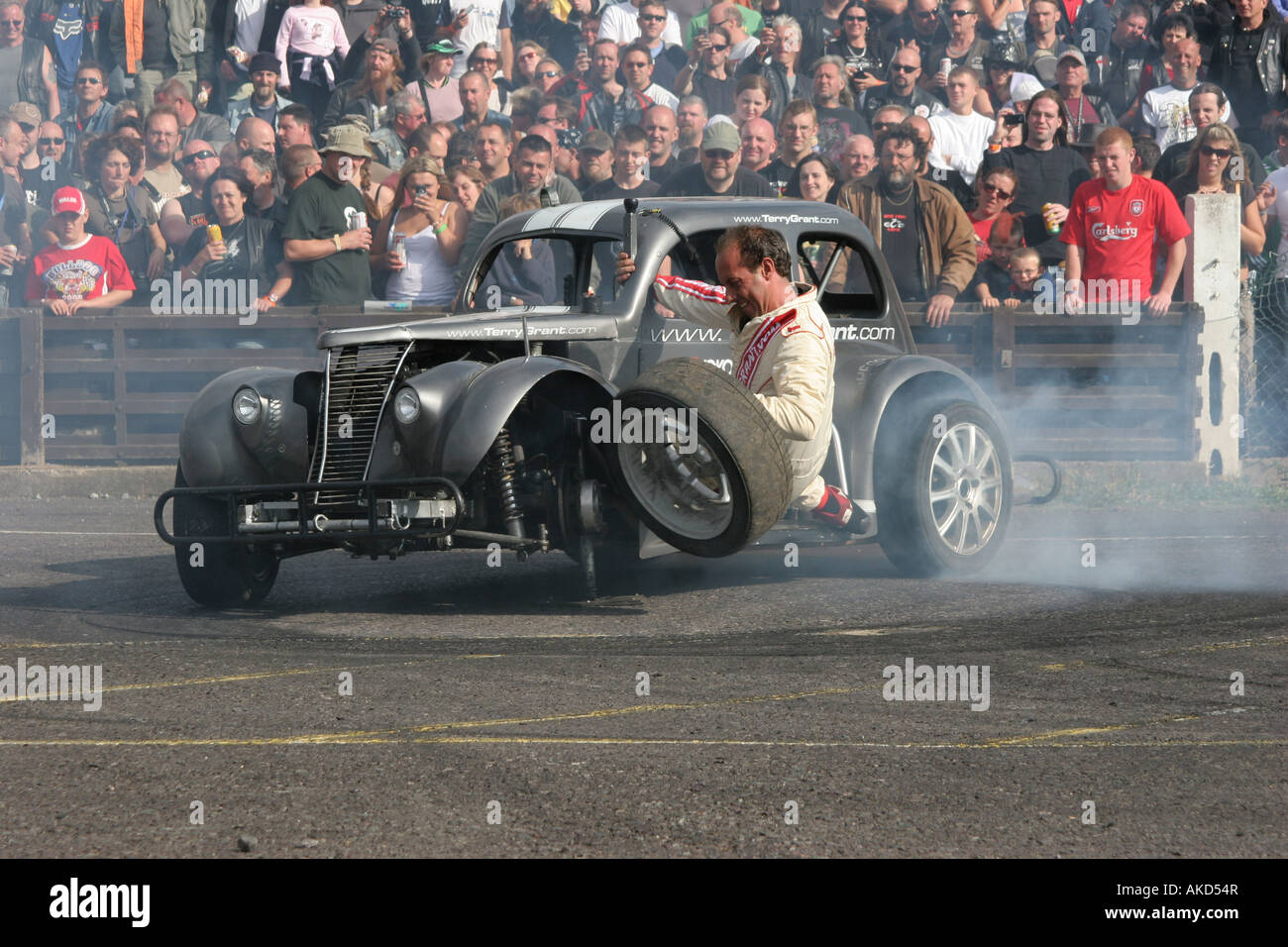 Stunt Man Terry Grant changes a tyre on a wheelspinning car ...