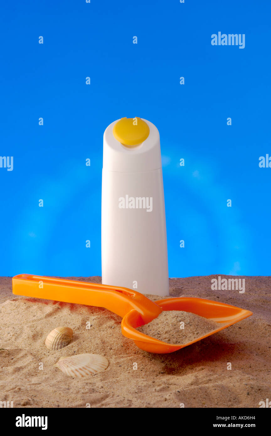 Studio shot of a white plastic unbranded sunscreen bottle on sand with ...