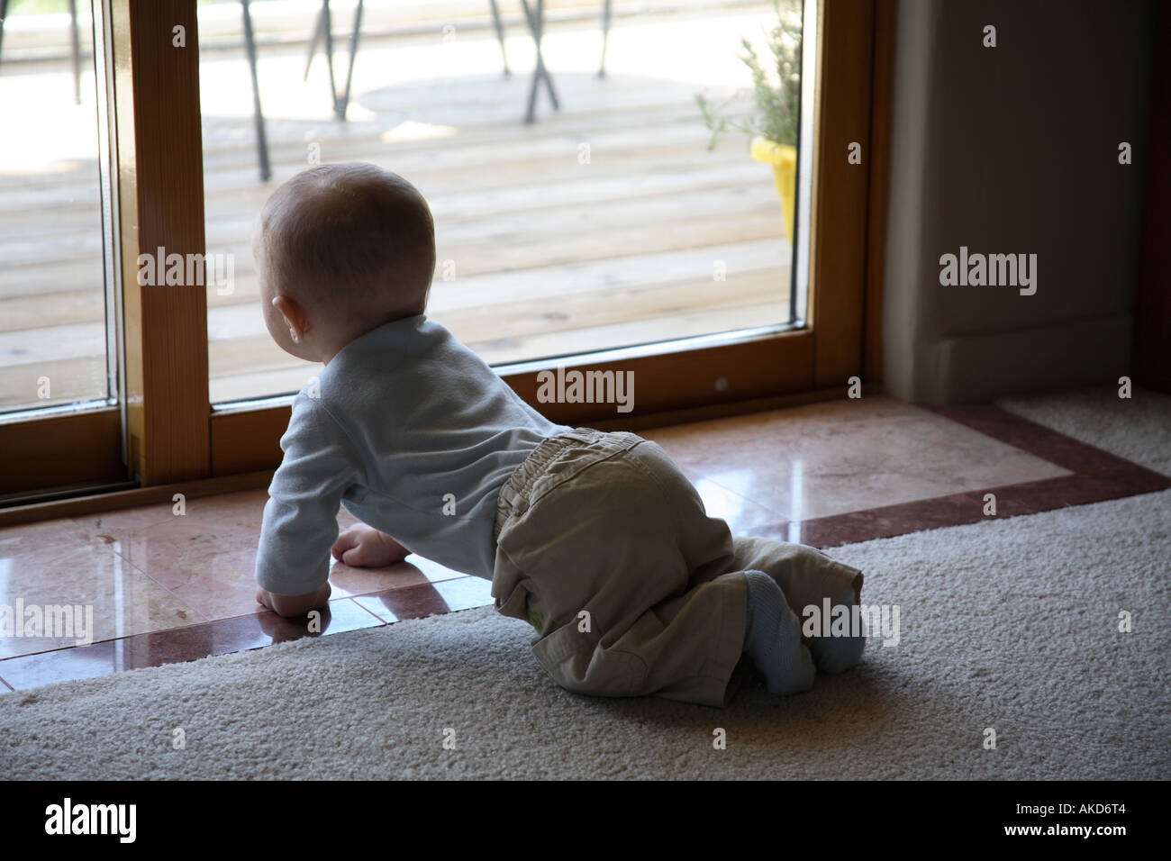Baby Boy Looking Out Window MR Stock Photo - Alamy