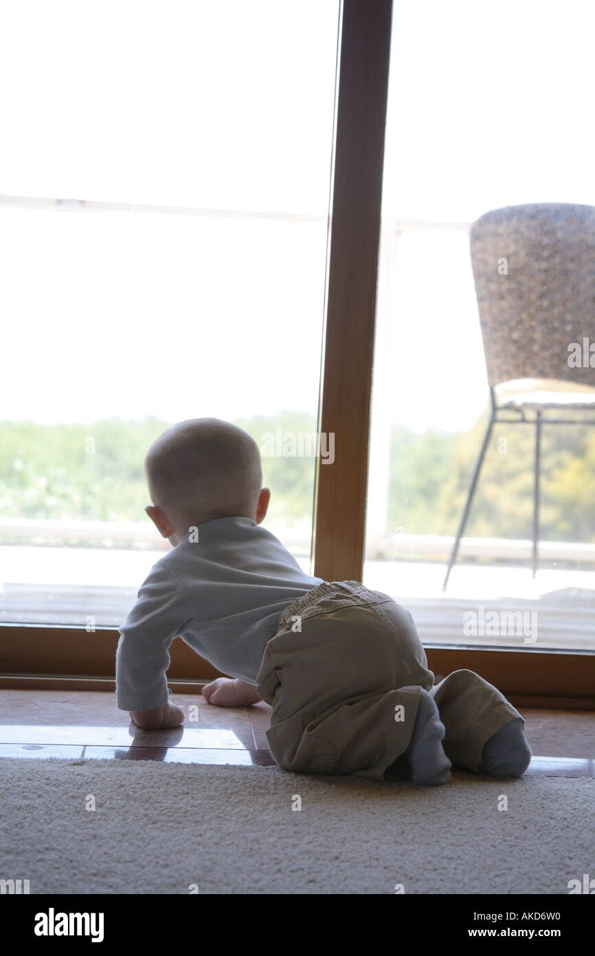 Baby Boy Looking Out Window MR Stock Photo - Alamy