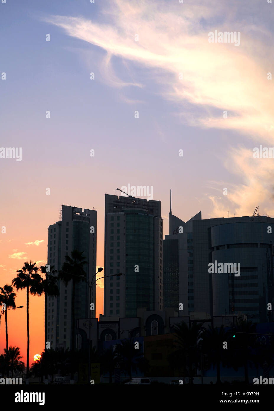 The sun sets behind some of the high rise buildings in Doha Qatar Stock ...