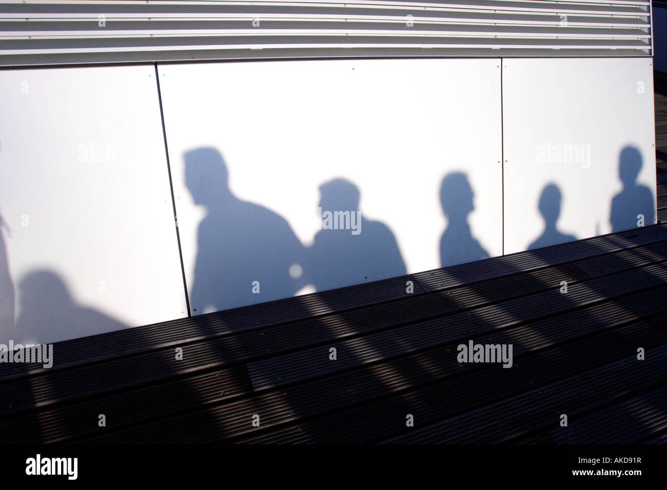 Silhouette shadows of people against a wall Stock Photo - Alamy