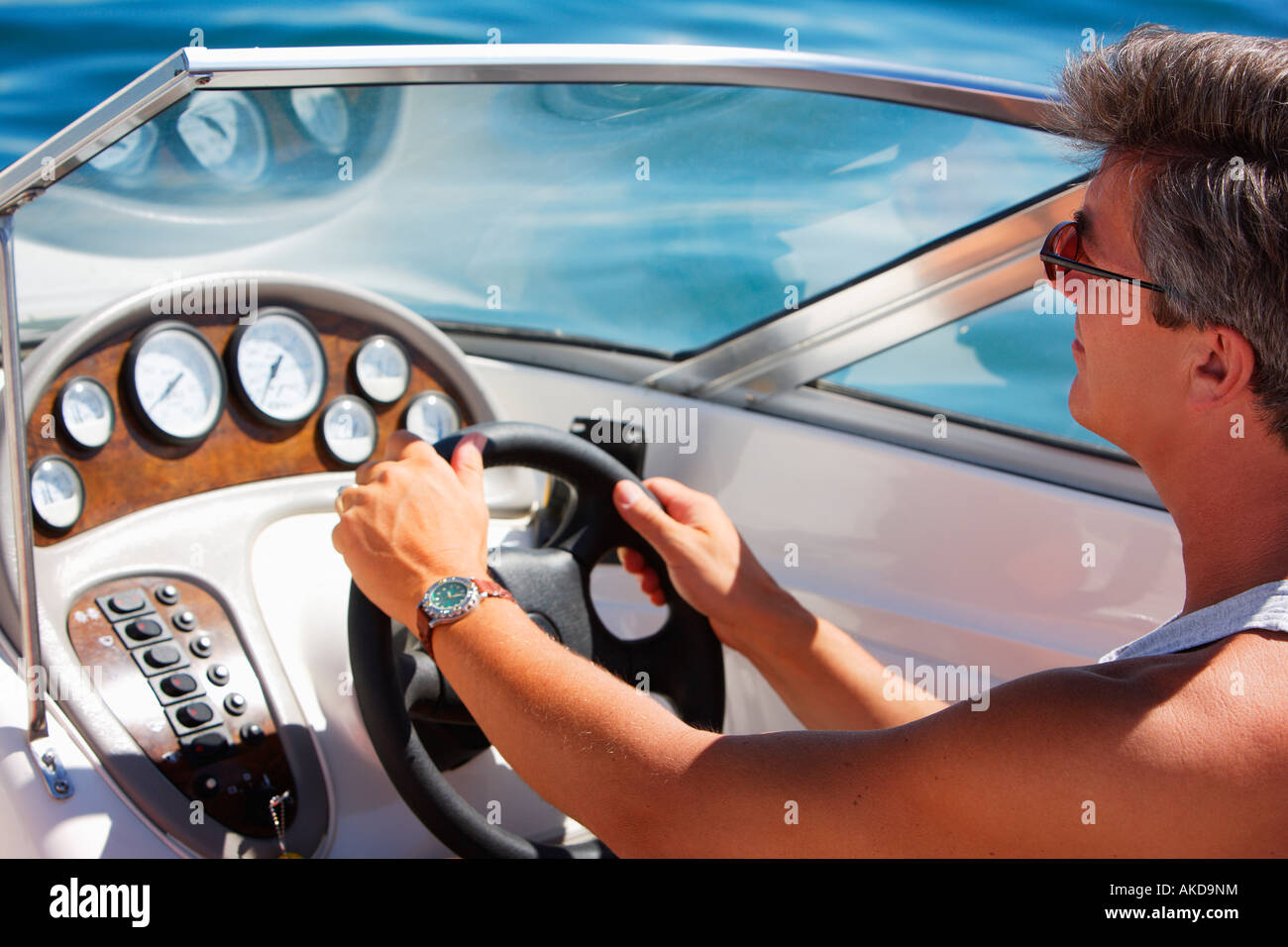 A man driving a speed boat Stock Photo - Alamy