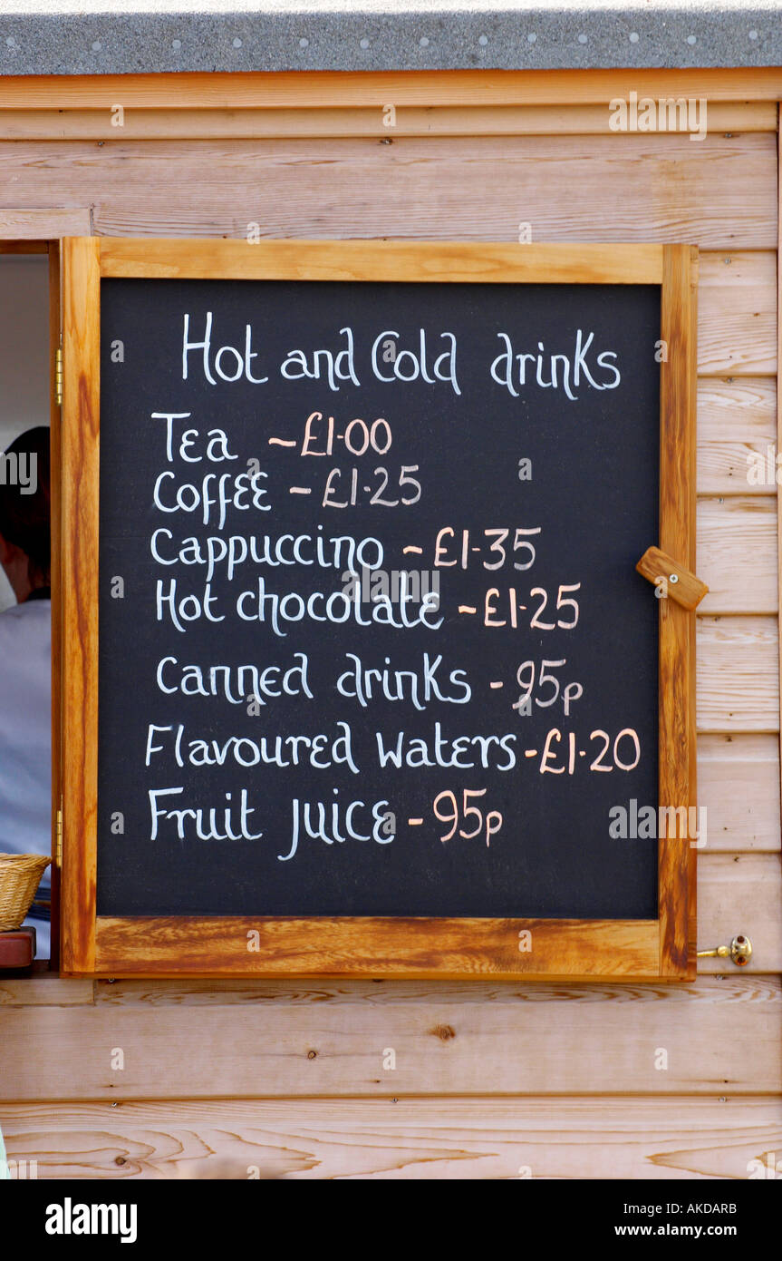 Cafe chalkboard menu for hot and cold drinks on the side of a wooden ...
