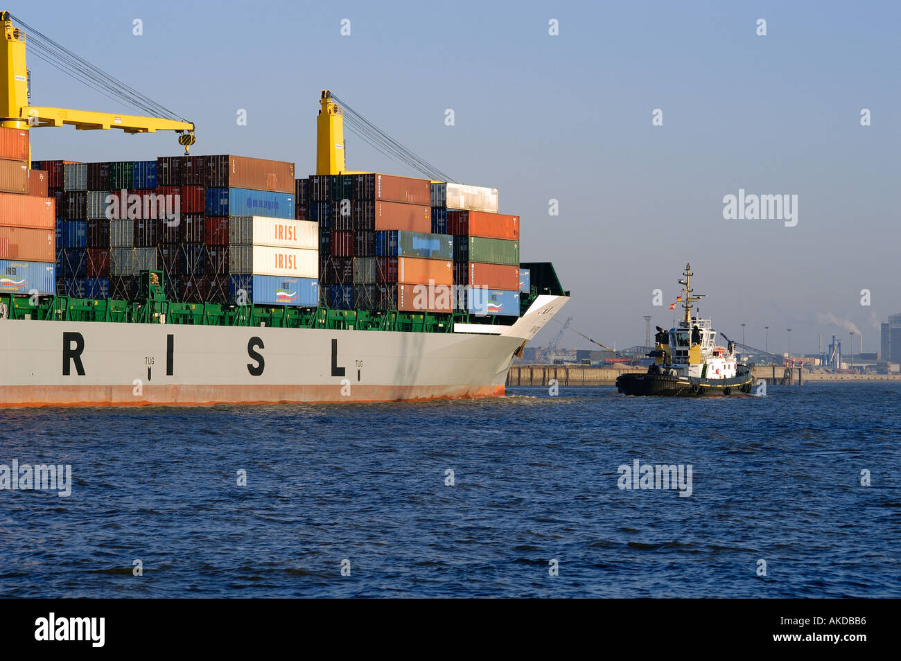 Tugs moving a container ship in the port of Hamburg Germany Stock Photo ...