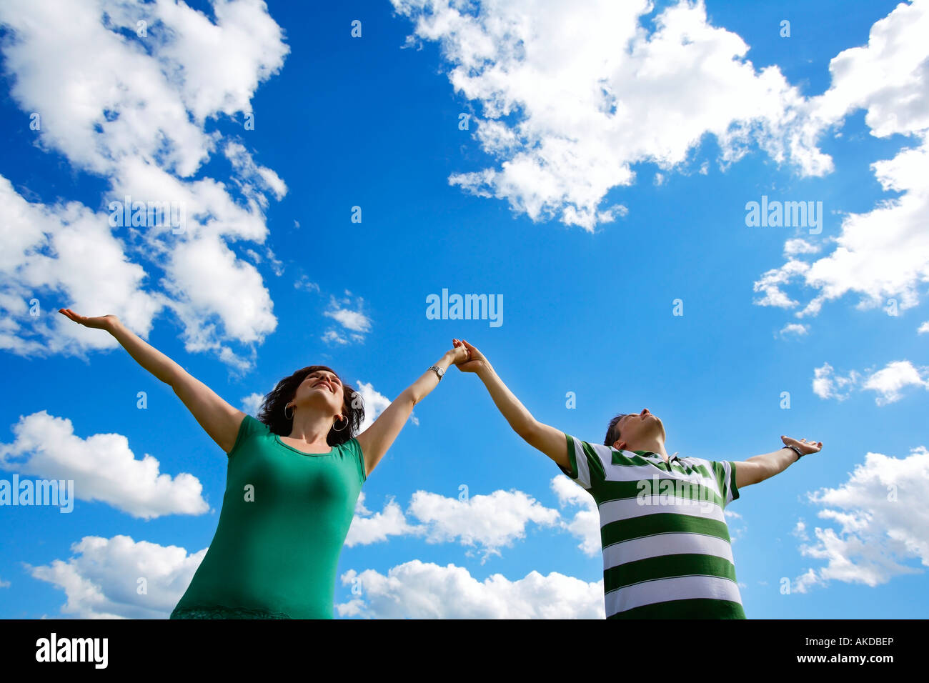 Couple with arms outstretched Stock Photo - Alamy
