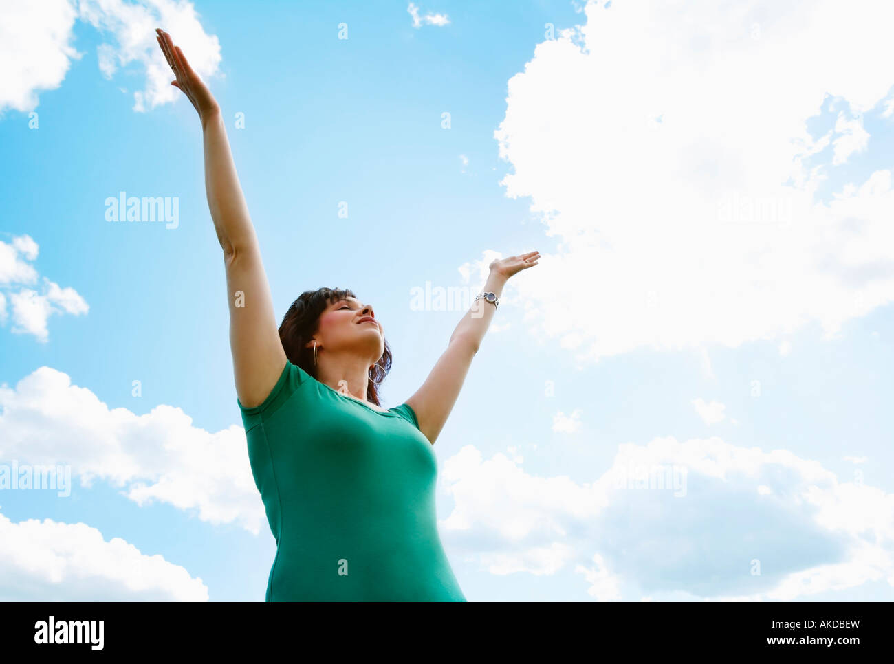 Woman with arms raised Stock Photo - Alamy