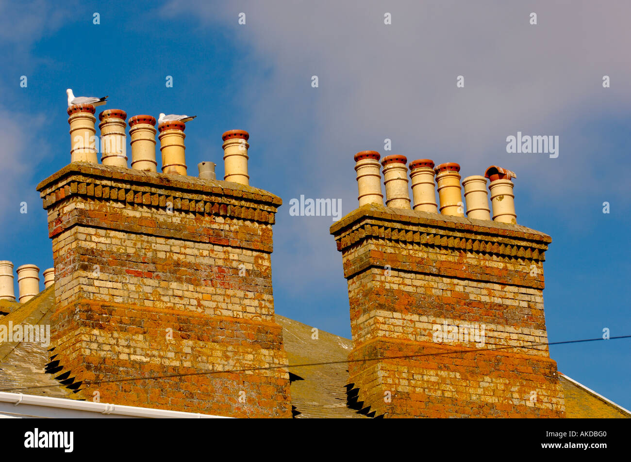 Chimney stacks built with two types of brick to create a striped ...