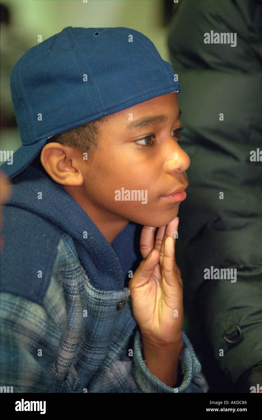 Teen age 13 looking curiously into distance at youth center. St Paul ...