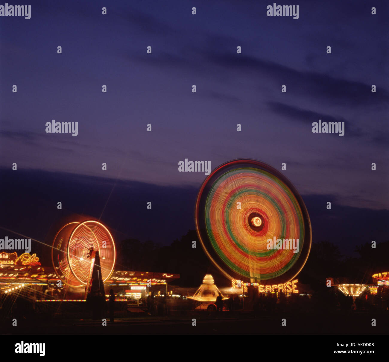 a Fun Fair on Ealing Common shot at dusk with the large wheel. and ...