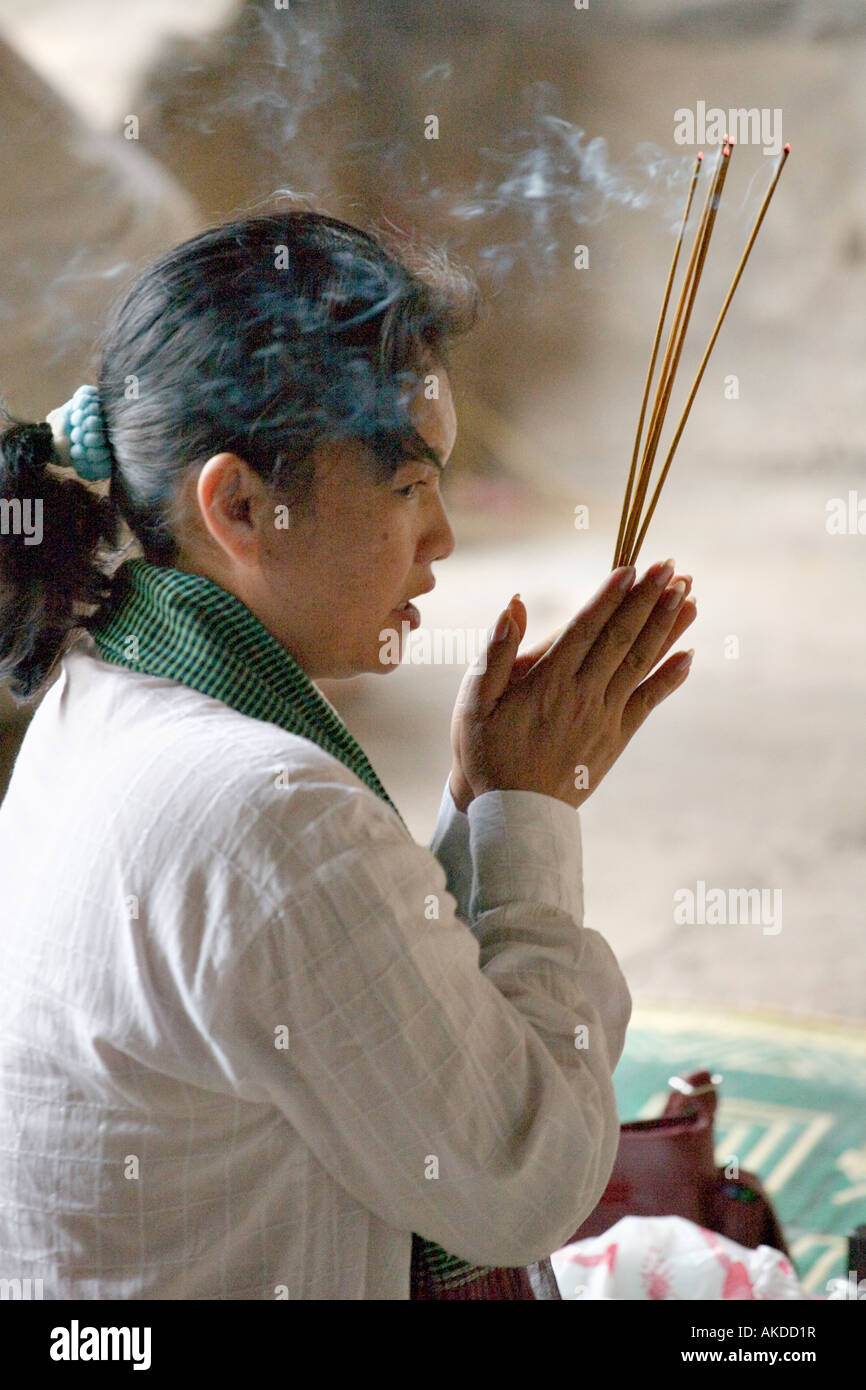 Woman with joss sticks praying, Angkor Wat, Angkor, Cambodia Stock ...