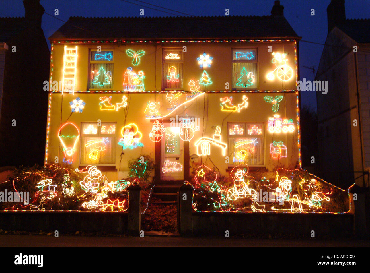 house front covered in garish Christmas lights Cornwall England UK ...