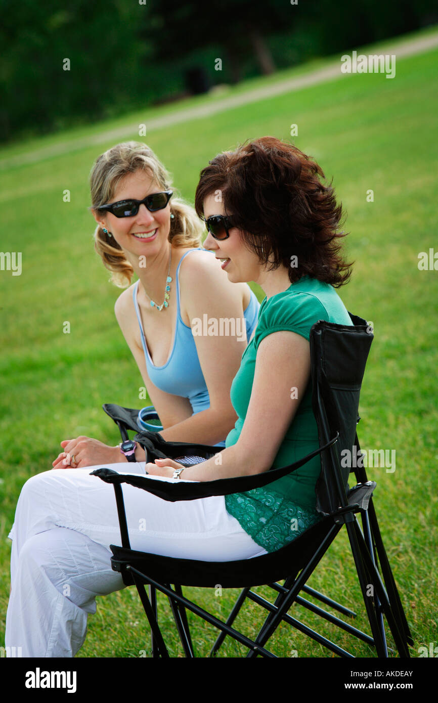 Women sitting together Stock Photo - Alamy