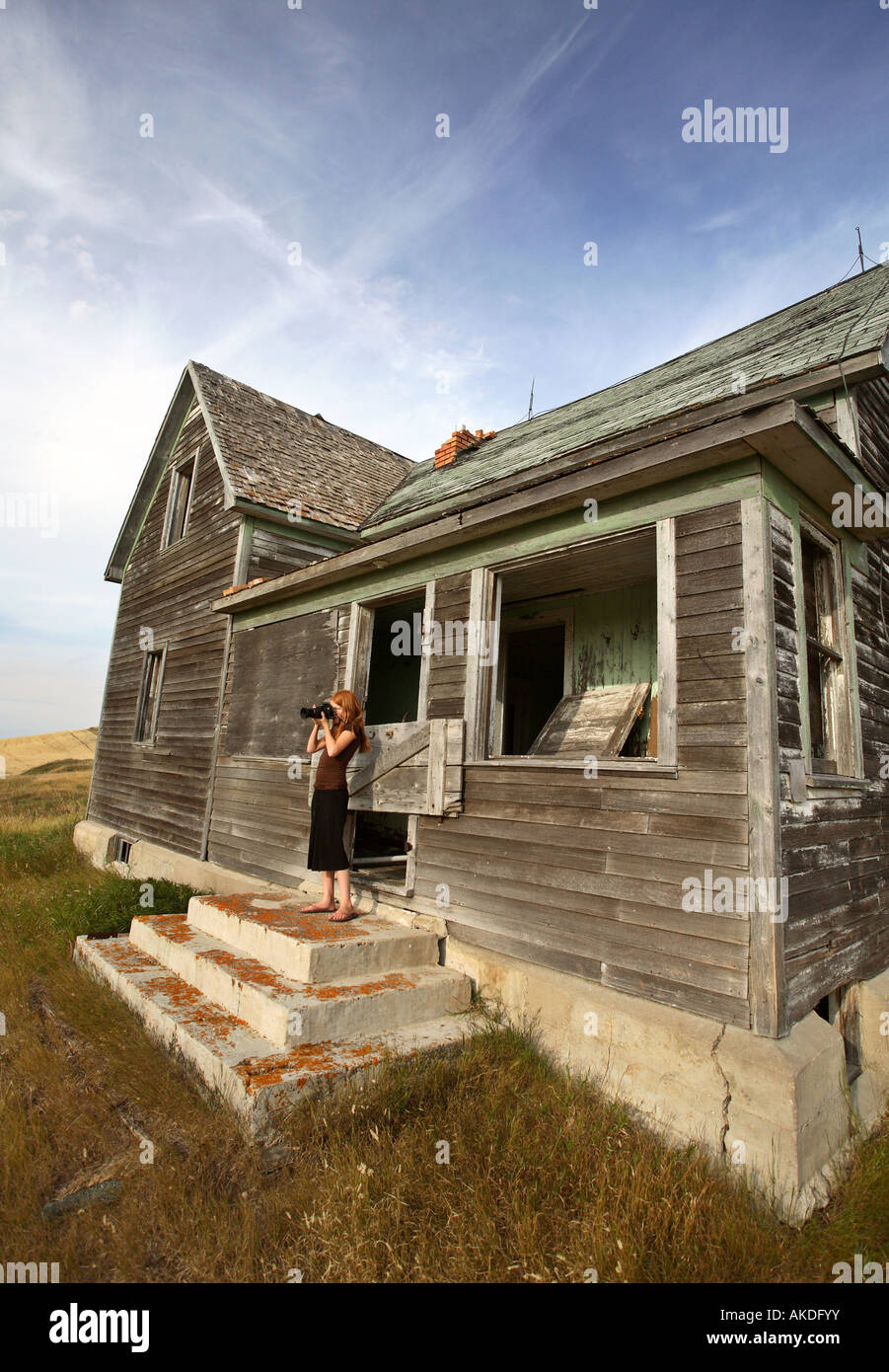 Young photographer in front of old Saskatchewan farm house Stock Photo ...