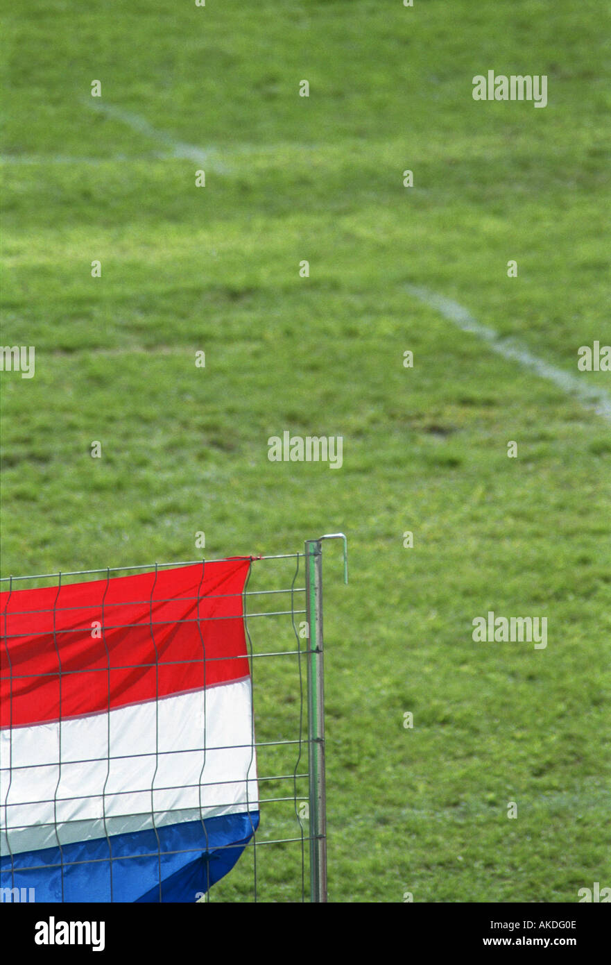 the dutch national flag hanging on fence by sports field Stock Photo ...