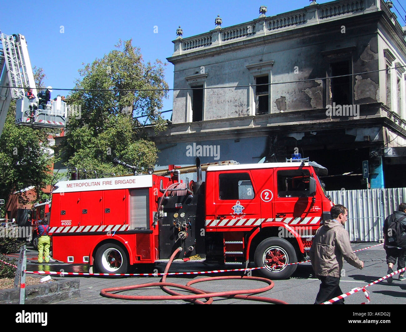 A fire truck outside a burnt house Stock Photo - Alamy