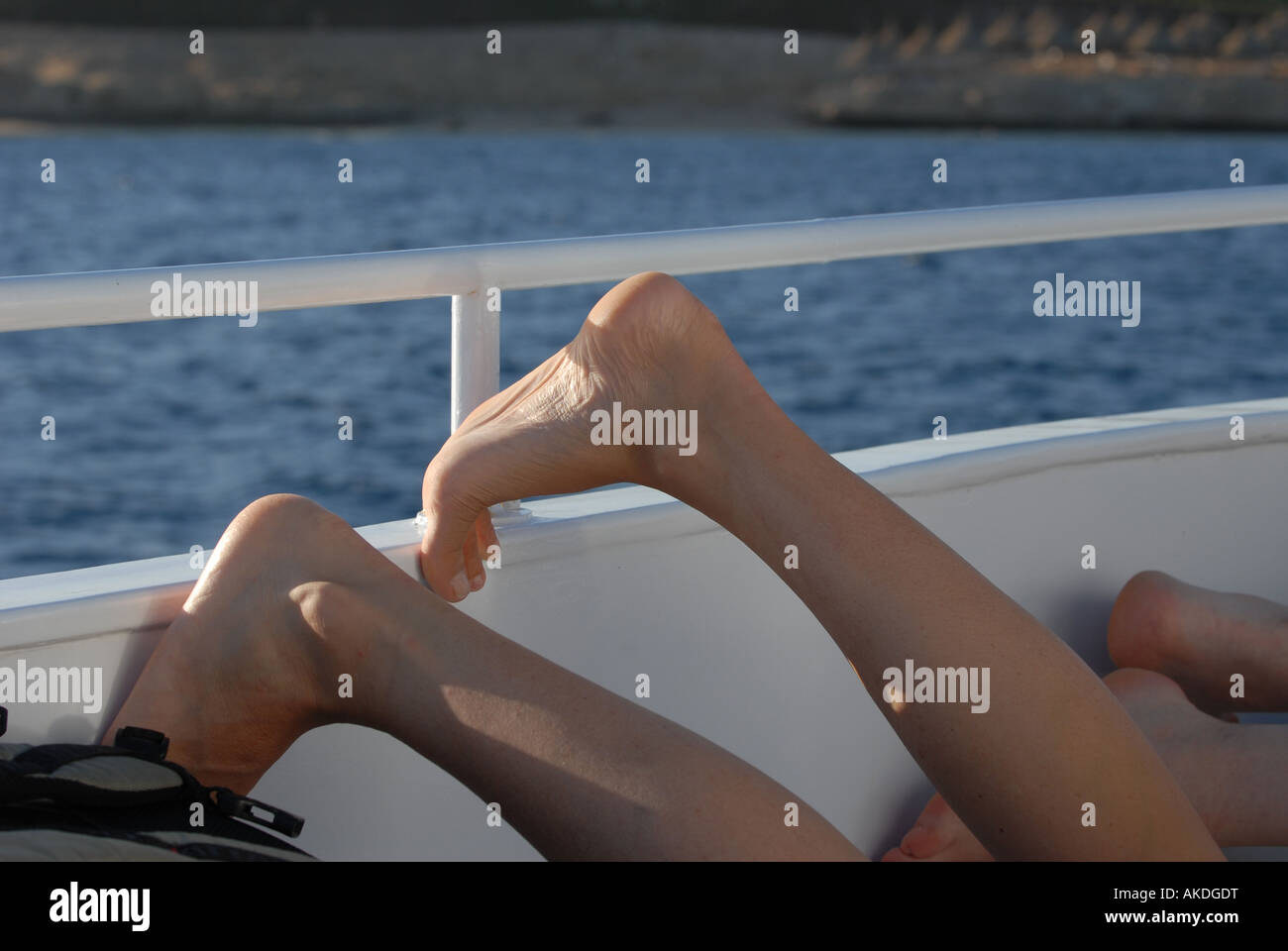 Feet relaxing on a diving boat Stock Photo - Alamy