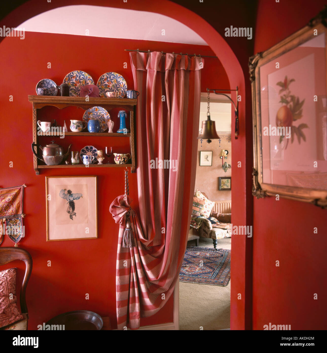Red curtain over interior door in small red eighties hall with view of ...