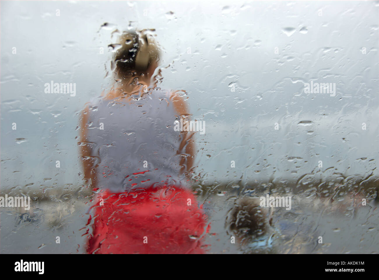 Mother and child through a rain washed window on a summer's day Stock ...