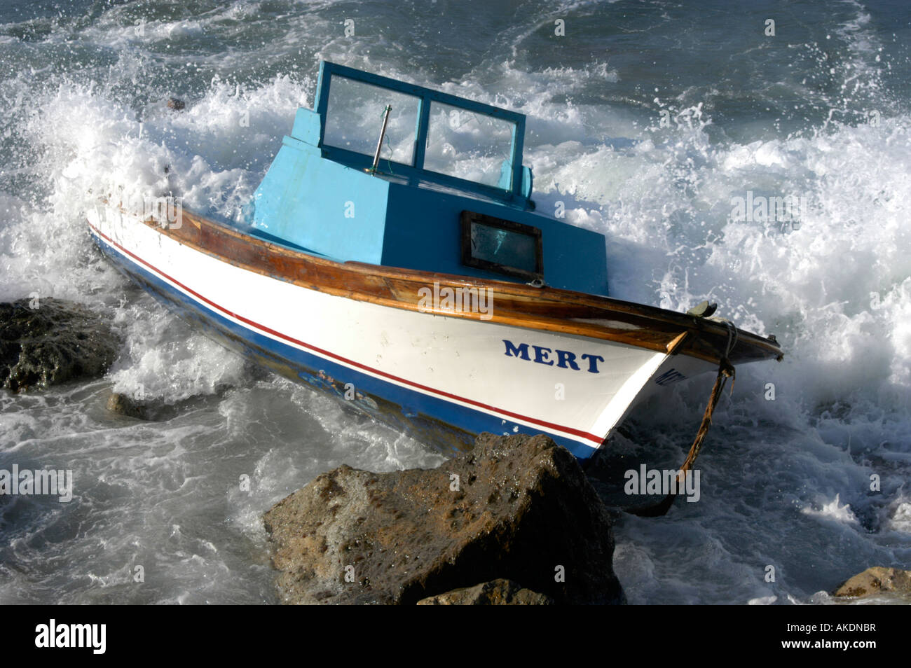 Capsized boat at the coast, Greece Stock Photo - Alamy