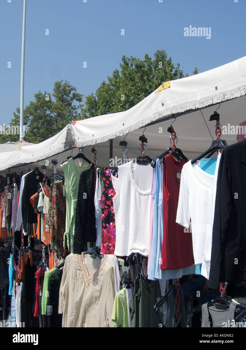 clothes hanging on market stall Stock Photo - Alamy