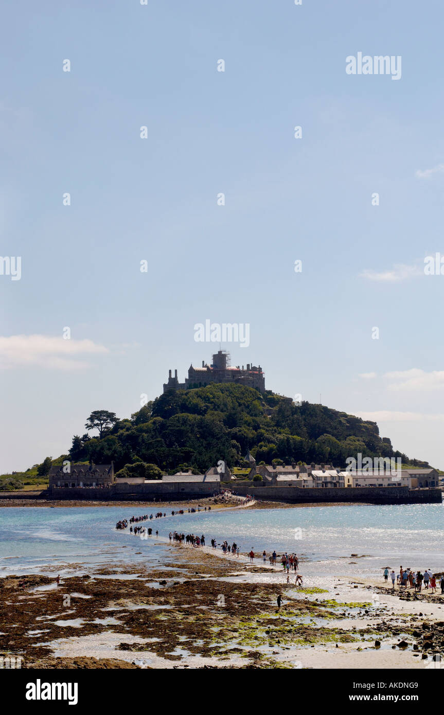 Visitors wade across the causeway, submerged in seawater to and from ...