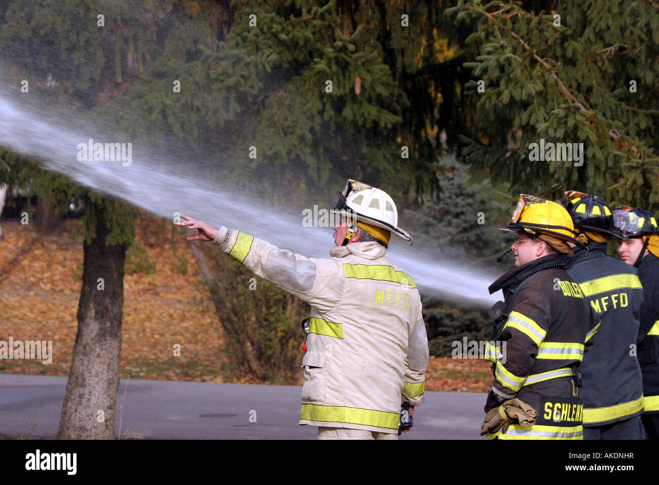 A commander firefighter teaching a team of firefighters on the location ...