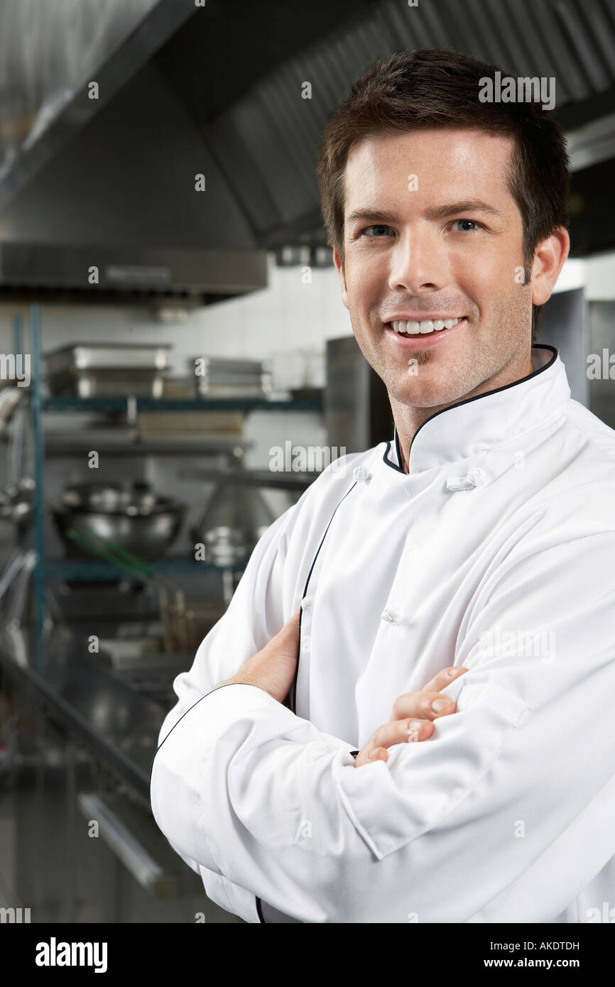 Male chef with arms crossed in kitchen, portrait Stock Photo - Alamy