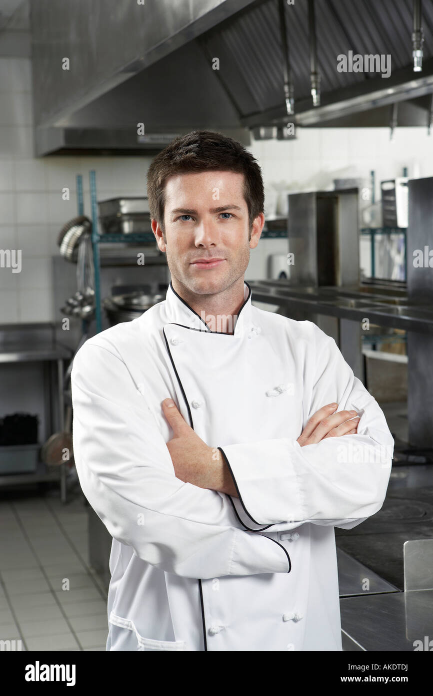 Male chef with arms crossed in kitchen, portrait Stock Photo - Alamy