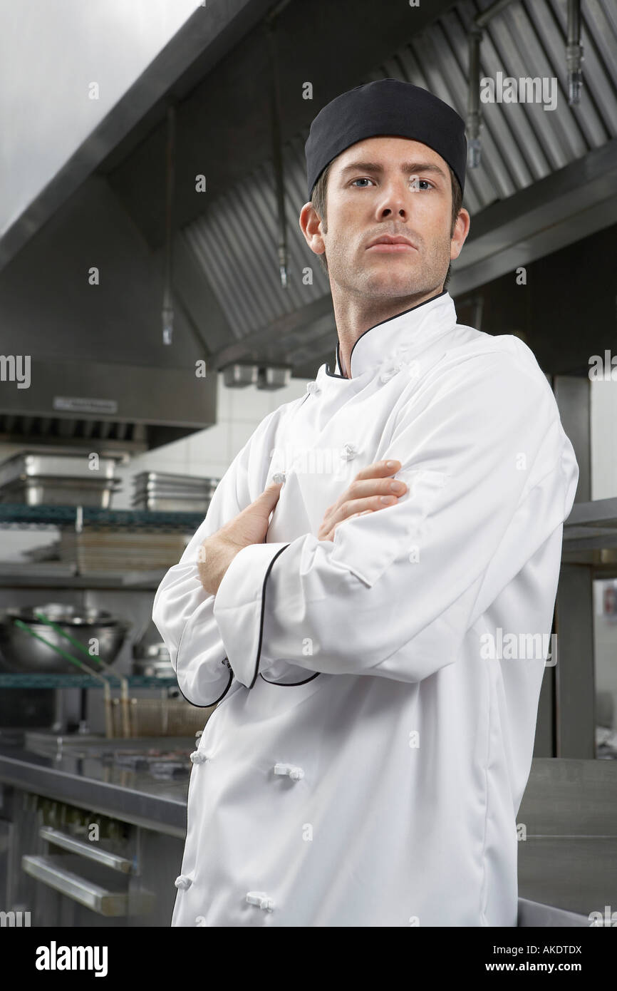 Male chef with arms crossed in kitchen, portrait Stock Photo - Alamy