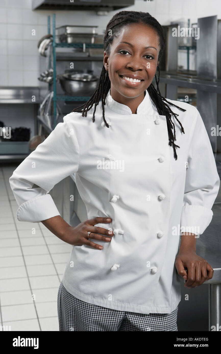 Female chef with hand on hip in kitchen, portrait Stock Photo - Alamy
