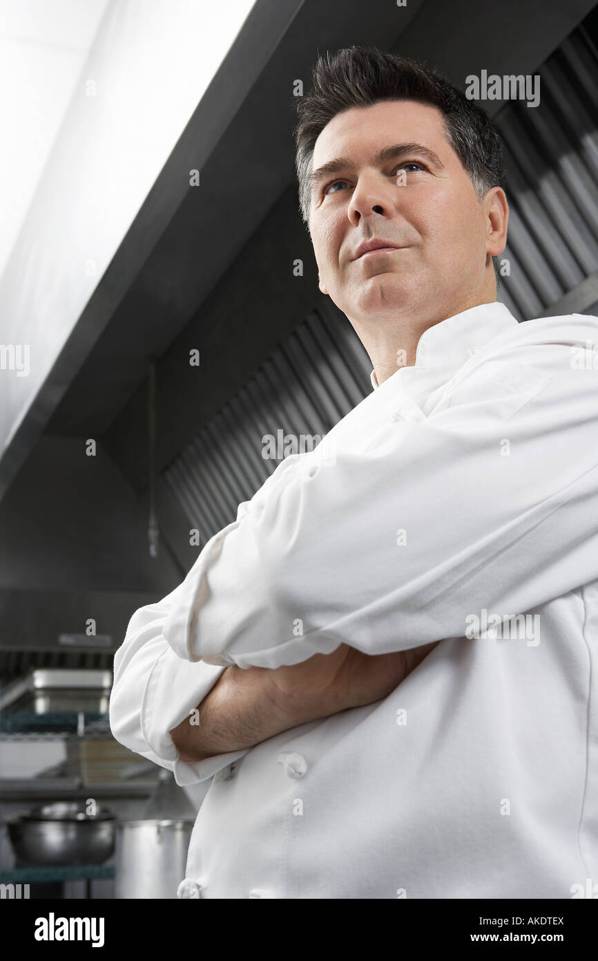 Male chef with arms crossed in kitchen, low angle view Stock Photo - Alamy