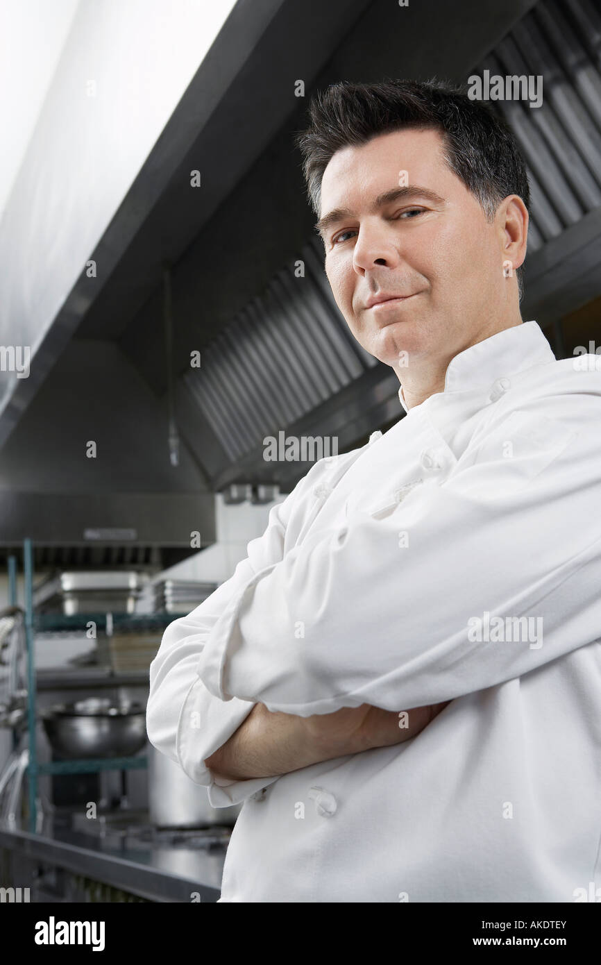 Male chef with arms crossed in kitchen, portrait Stock Photo - Alamy