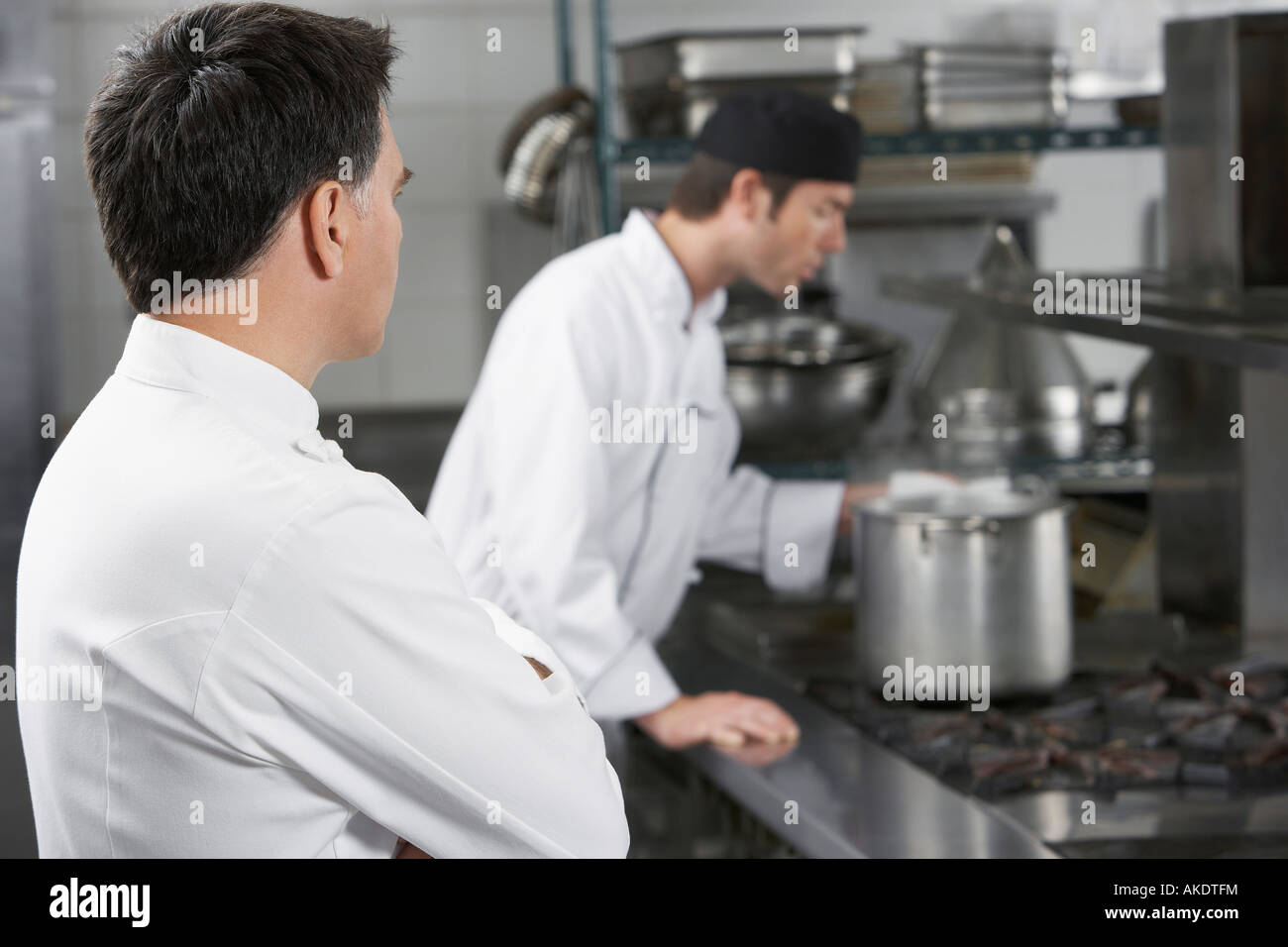 Two male chefs working in kitchen Stock Photo - Alamy