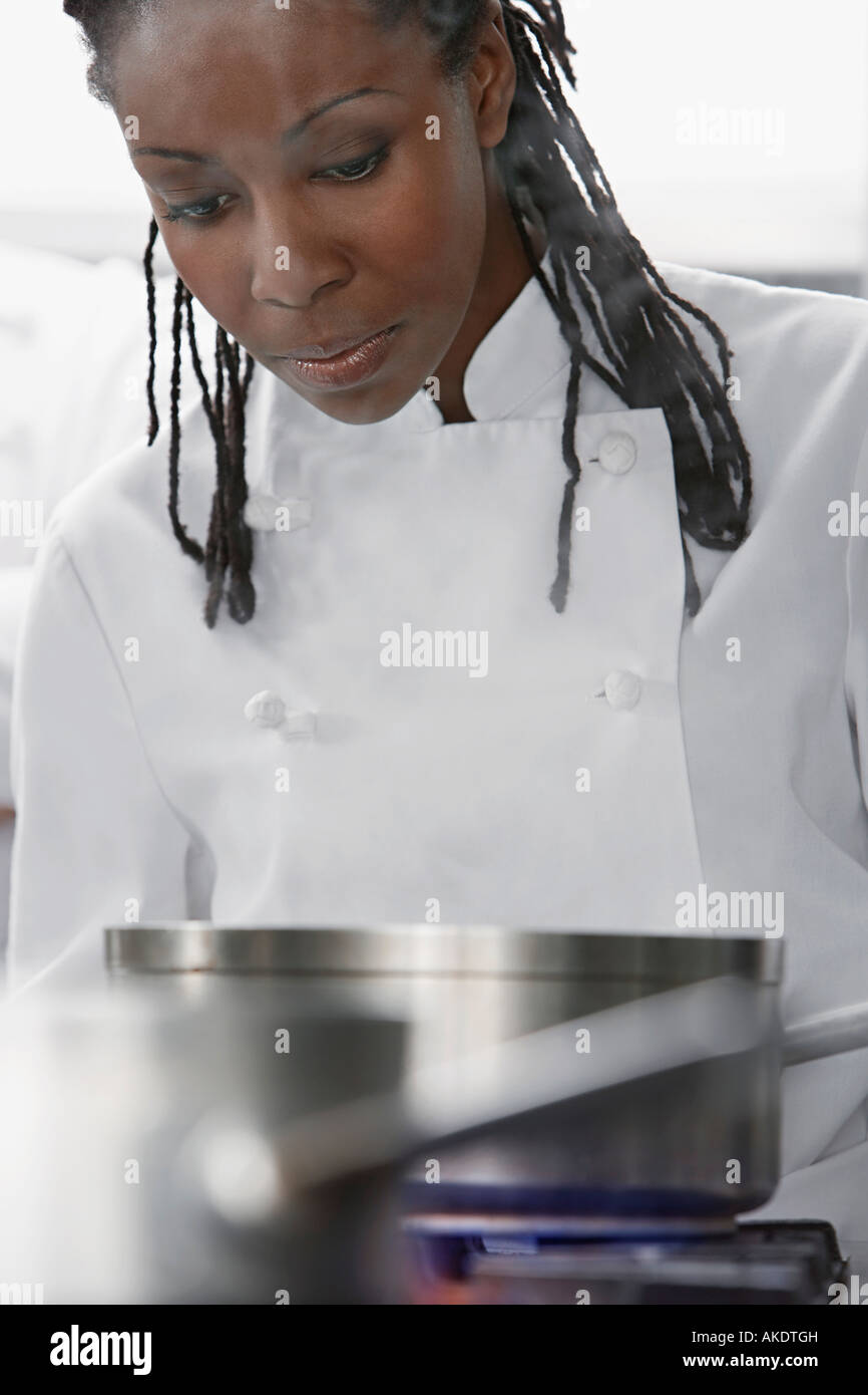 Female chef cooking in kitchen Stock Photo - Alamy