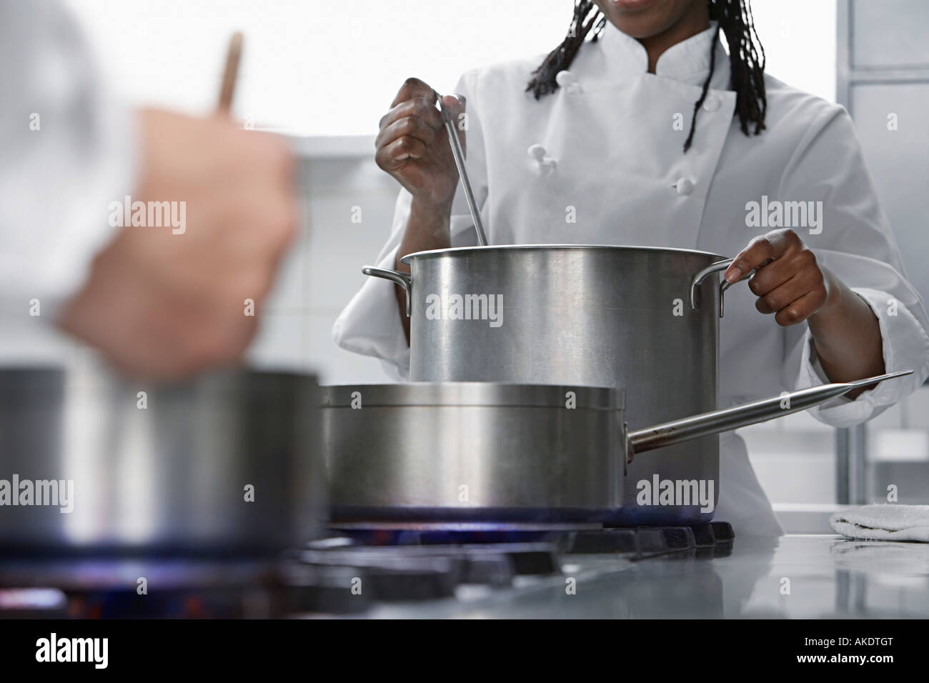 Female chef cooking in kitchen Stock Photo - Alamy
