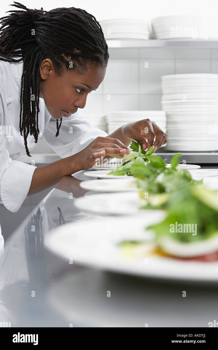 Female chef preparing salad in kitchen Stock Photo - Alamy