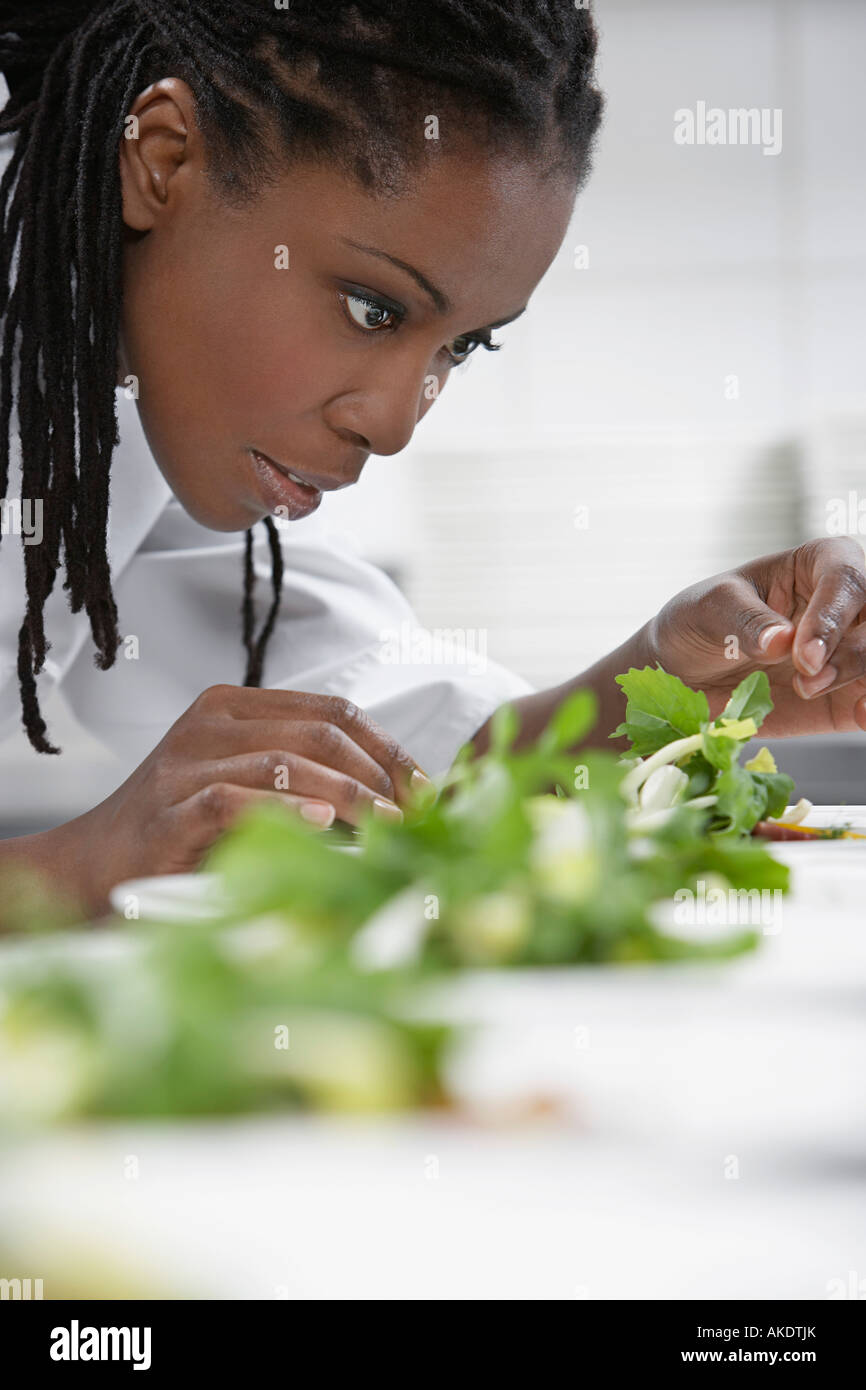 Female chef preparing salad in kitchen Stock Photo - Alamy