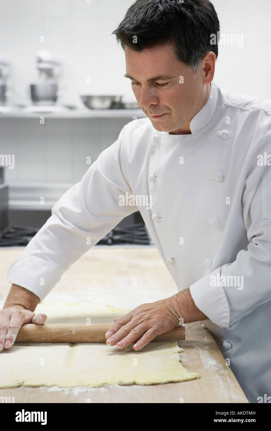 Chef rolling dough in kitchen Stock Photo - Alamy