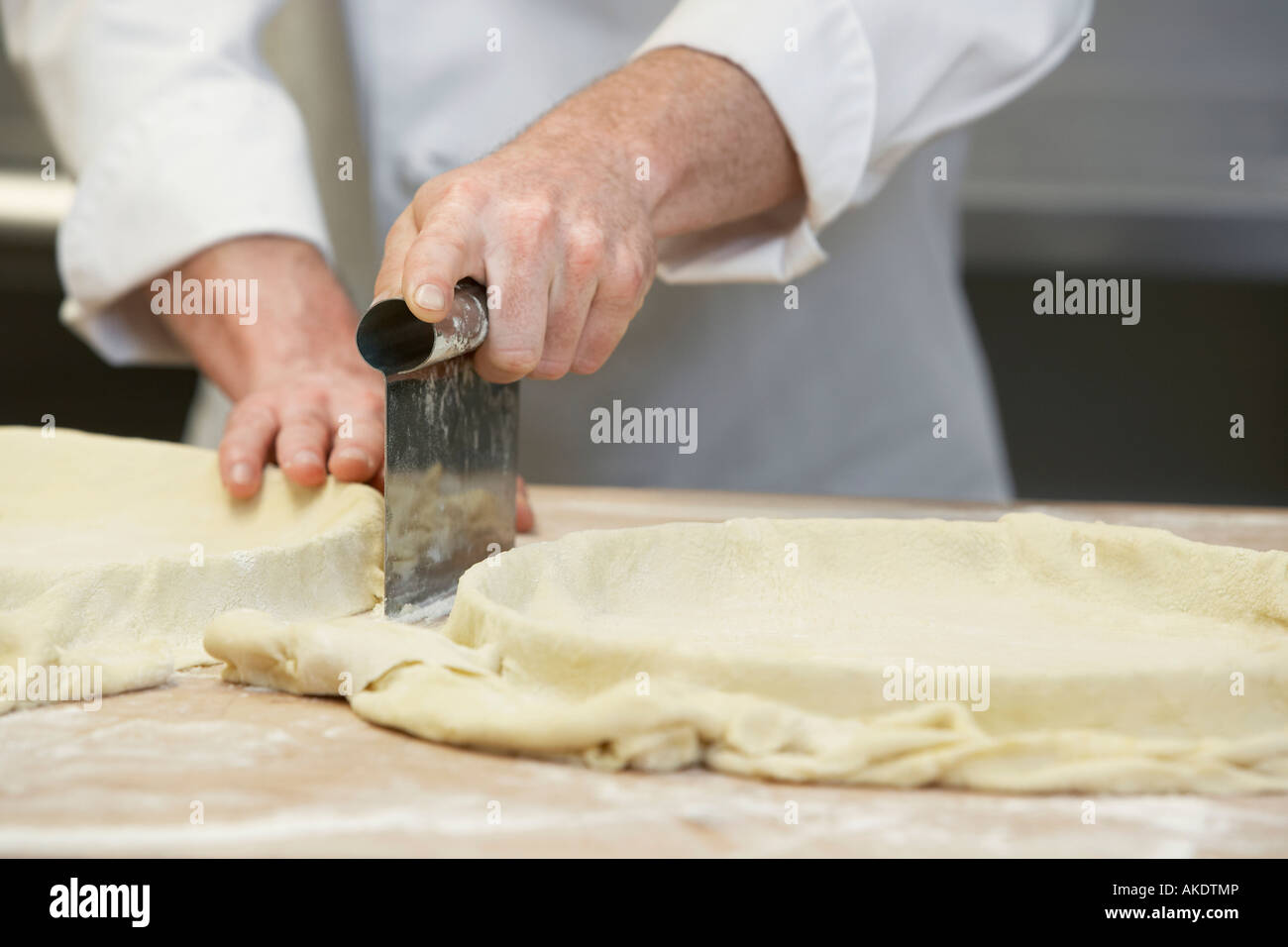 Chef cutting dough, close-up Stock Photo - Alamy