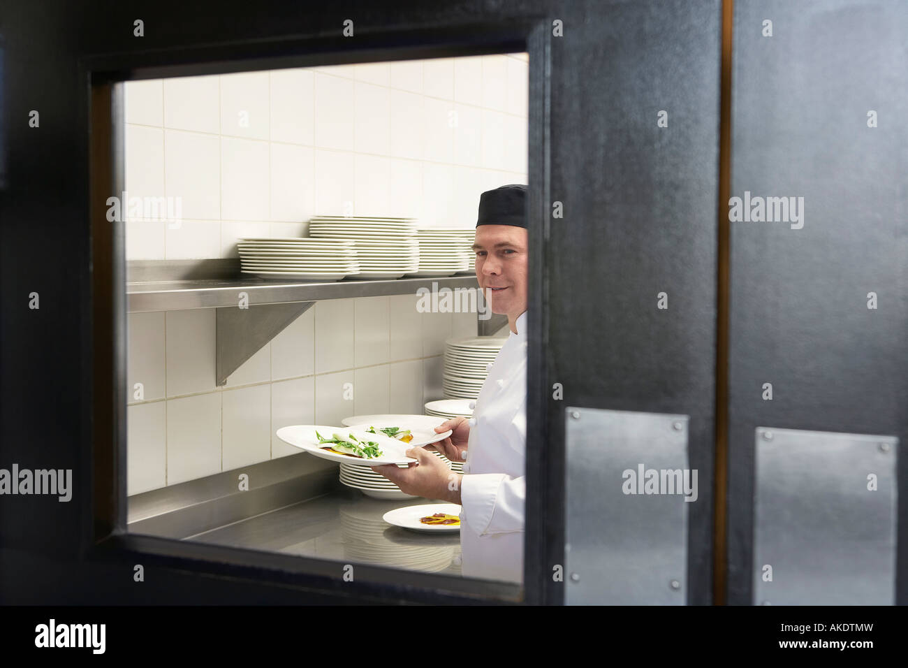 Person carrying stacked plates hi-res stock photography and images - Alamy