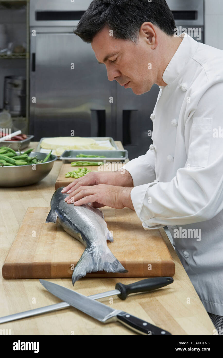Male chef preparing salmon in kitchen Stock Photo - Alamy