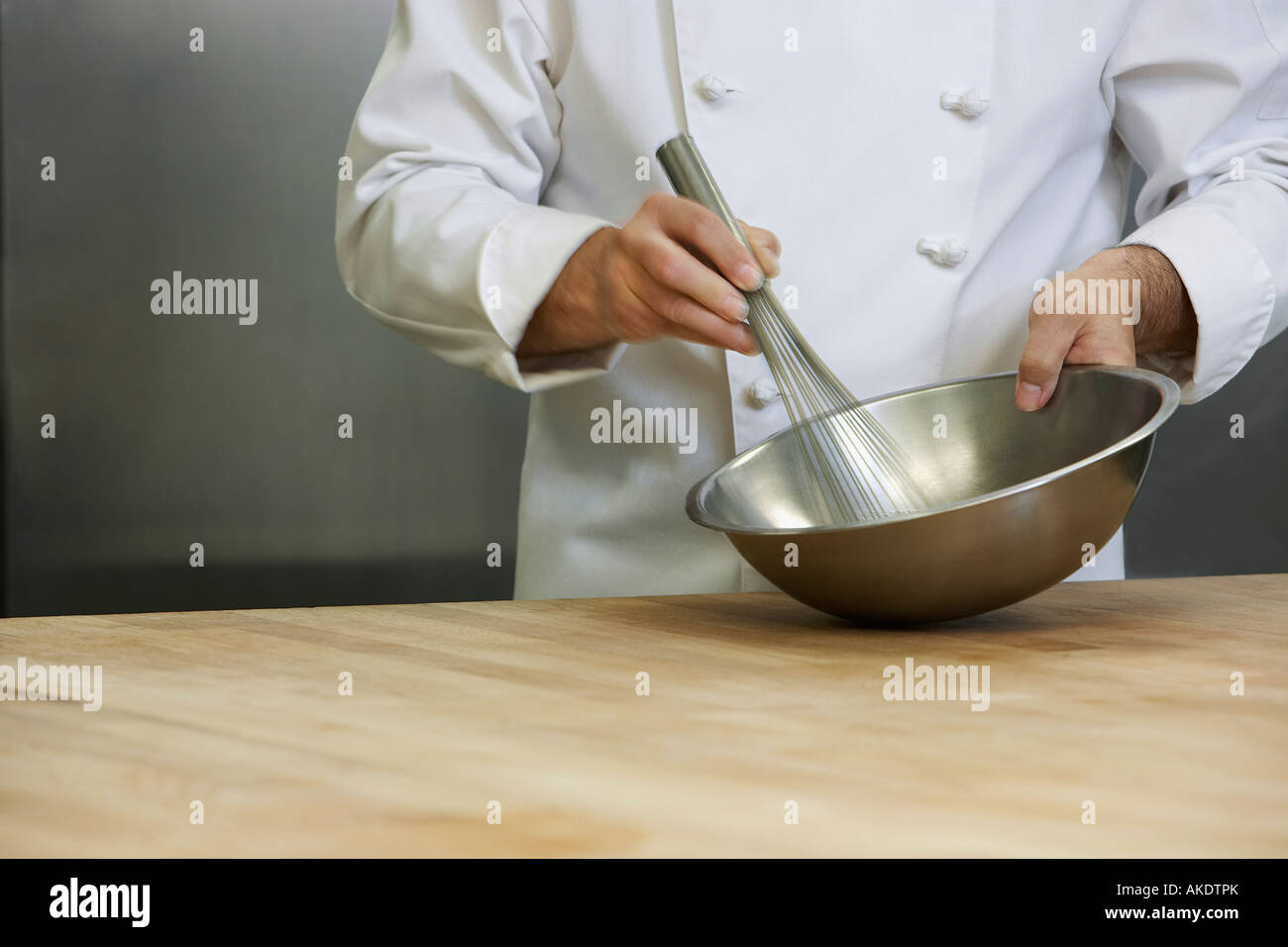 Male chef mixing ingredients using whisk, mid section Stock Photo - Alamy