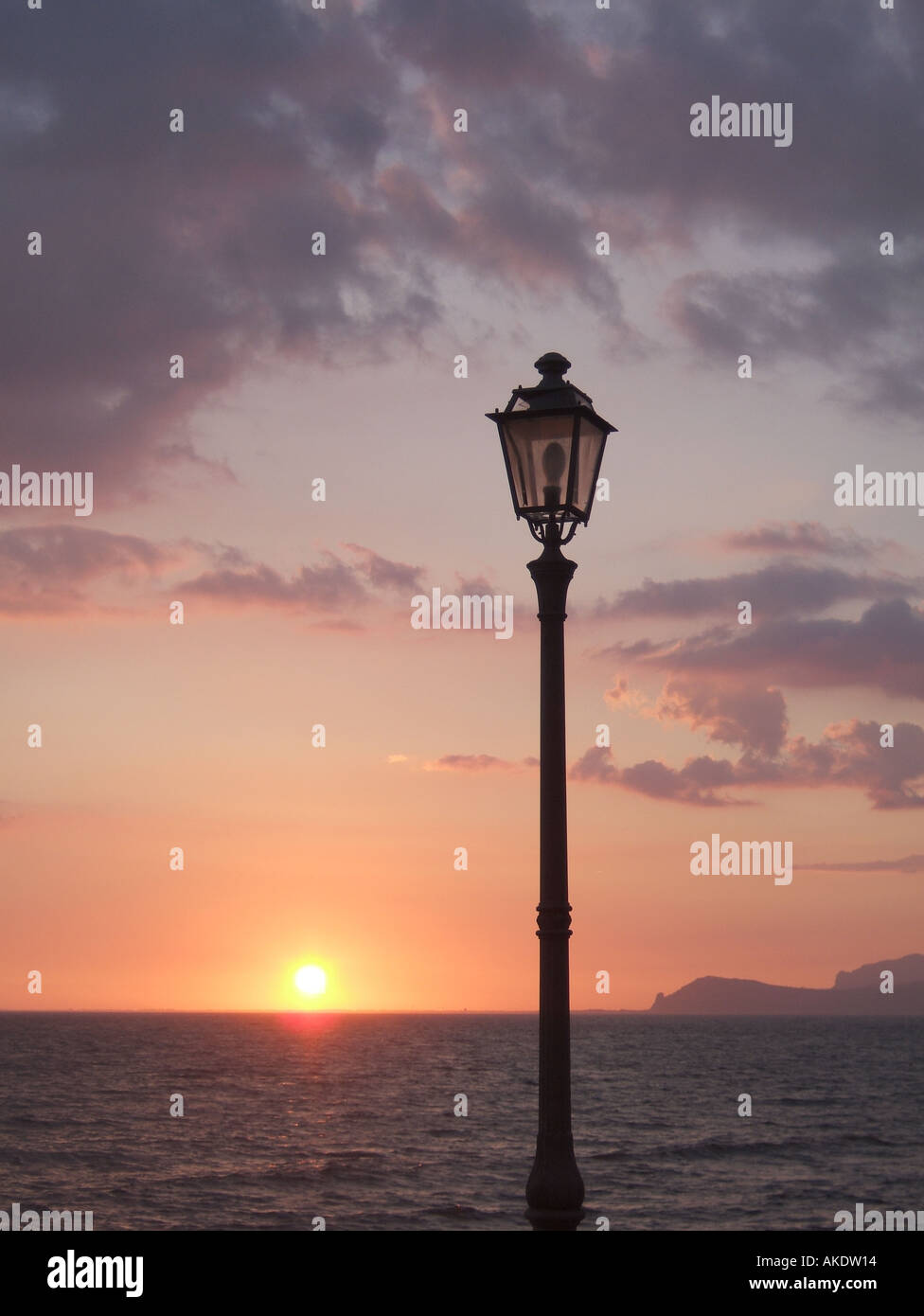 lamp post and sea at sunset Stock Photo - Alamy