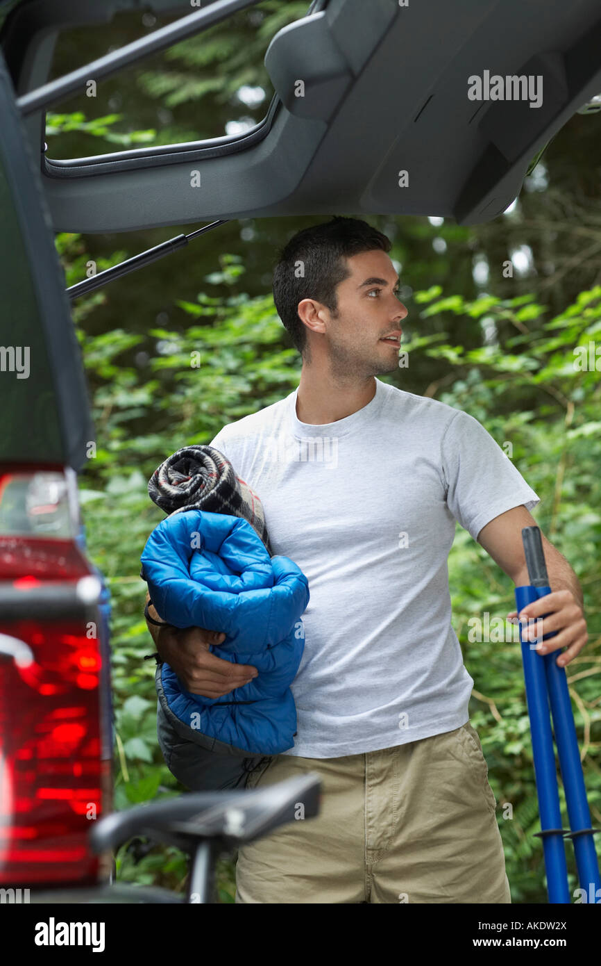 Man unloading car in countryside Stock Photo - Alamy