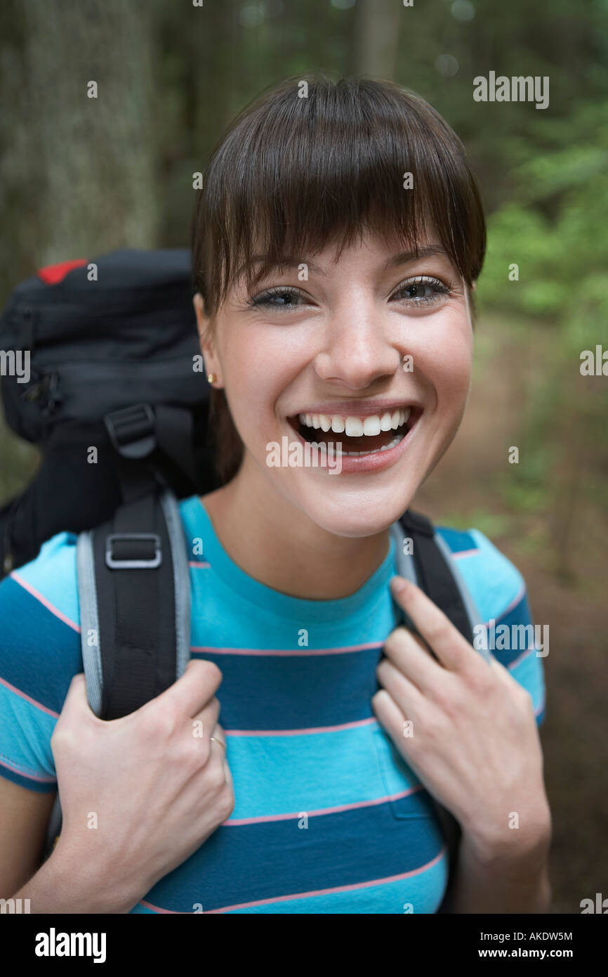 Woman wearing backpack, smiling, portrait Stock Photo - Alamy