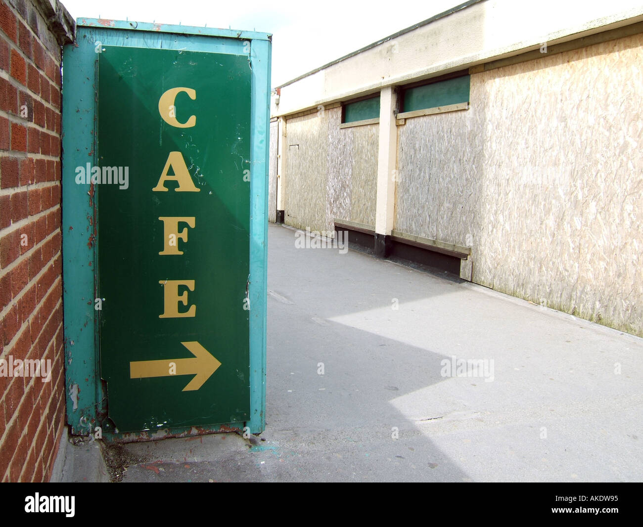 cafe sign with boarded up building Stock Photo - Alamy